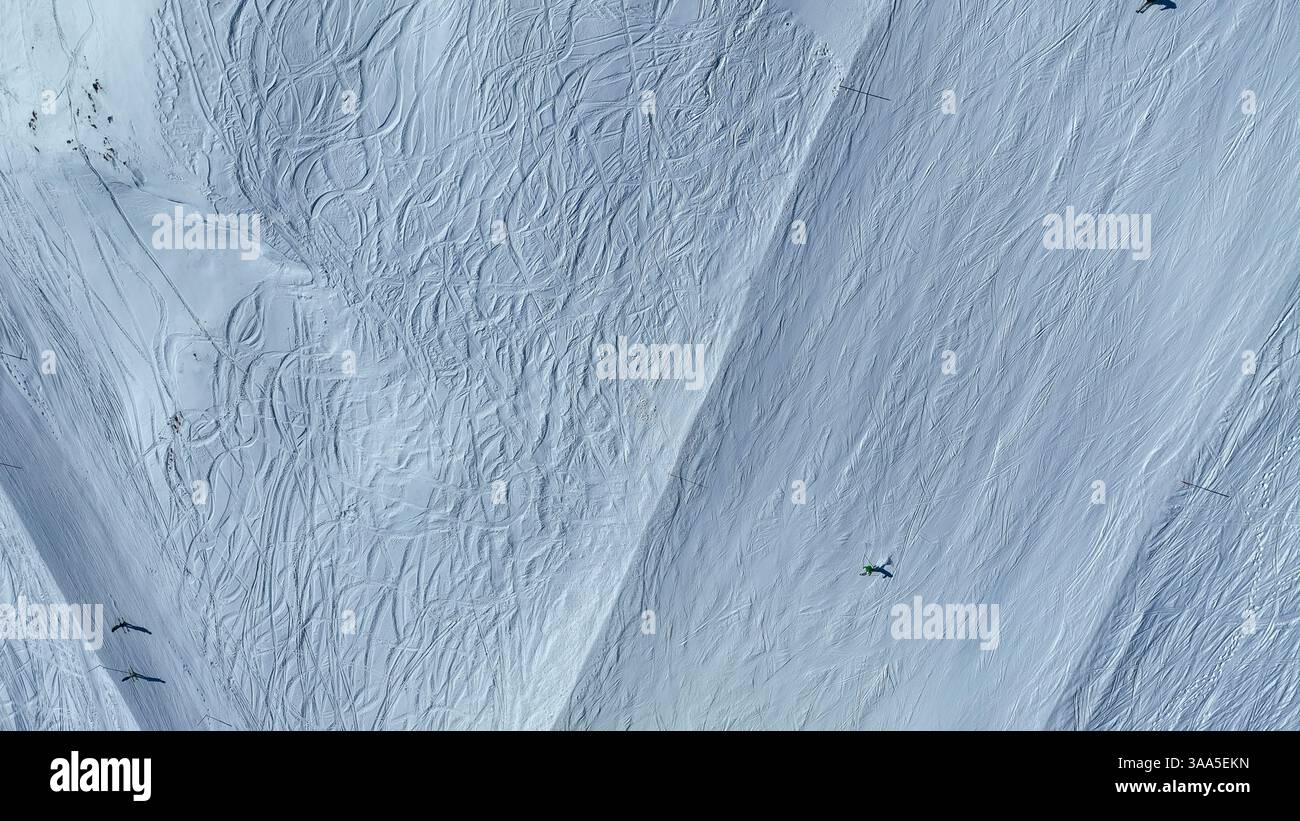 Skiers skiing downhill on a piste. Aerial View of Skier on Snowy ...