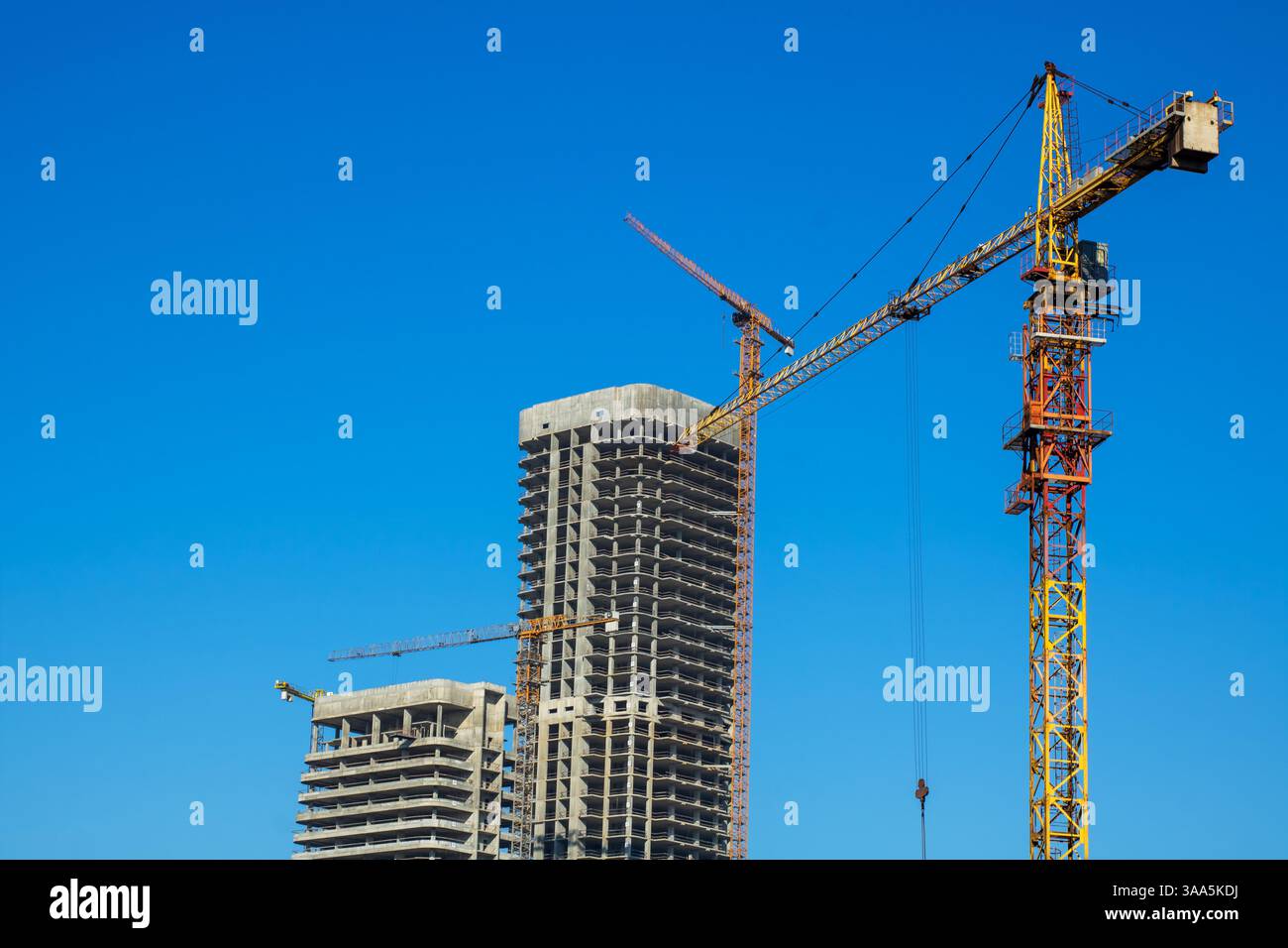 A bustling construction site featuring a brilliant blue sky in the ...