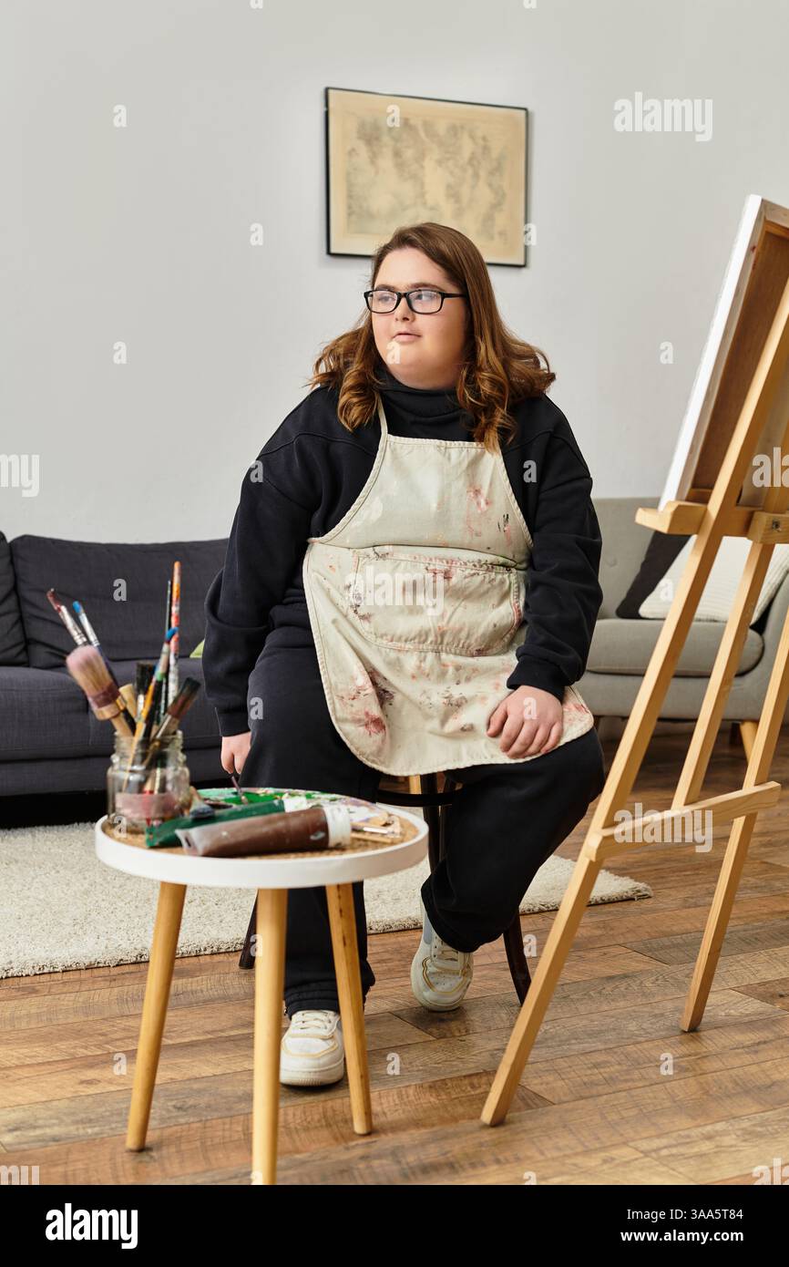 A young woman creates art at home, surrounded by painting supplies in a ...