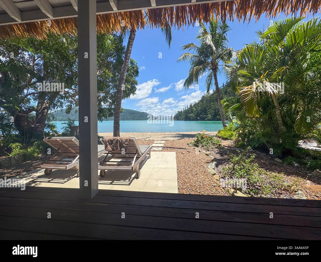 View from the chalet to the ocean. 2 deckchairs stand on the terrace ...