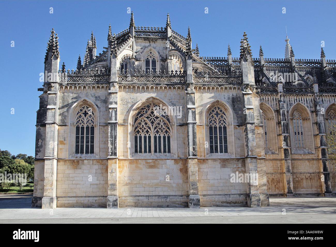 Visitors admire the intricate Gothic architecture of Batalha Monastery ...