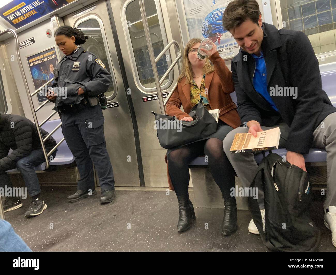 Riding on a subway train with an NYPD officer in New York on Wednesday ...