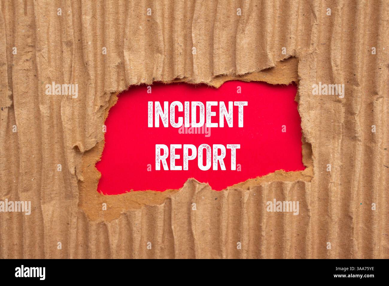 Incident report message written on ripped torn cardboard paper on red background. Conceptual ...