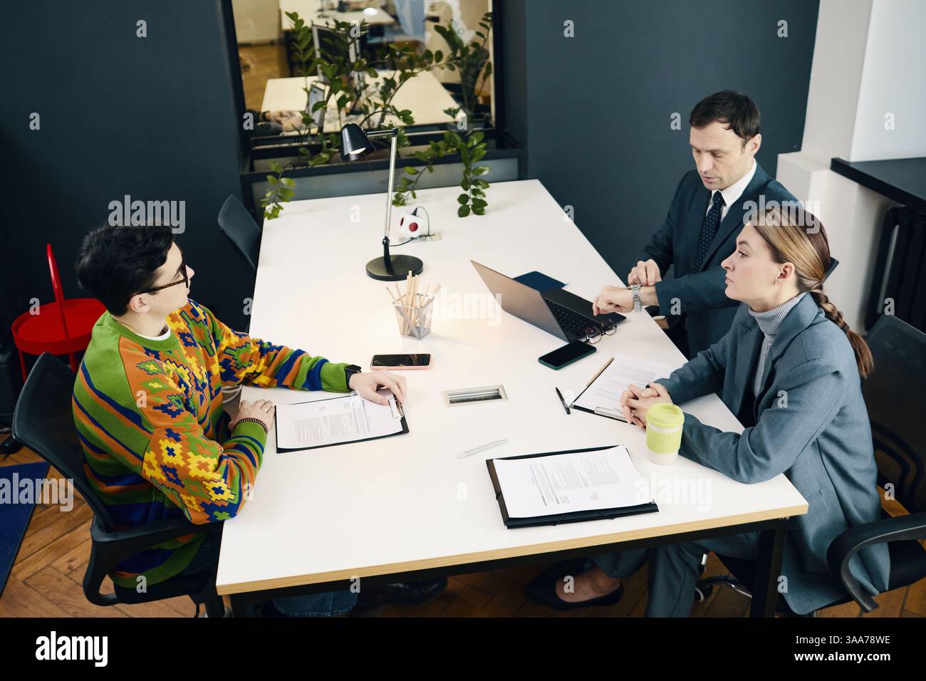 High angle view of employers listening to candidate during business ...