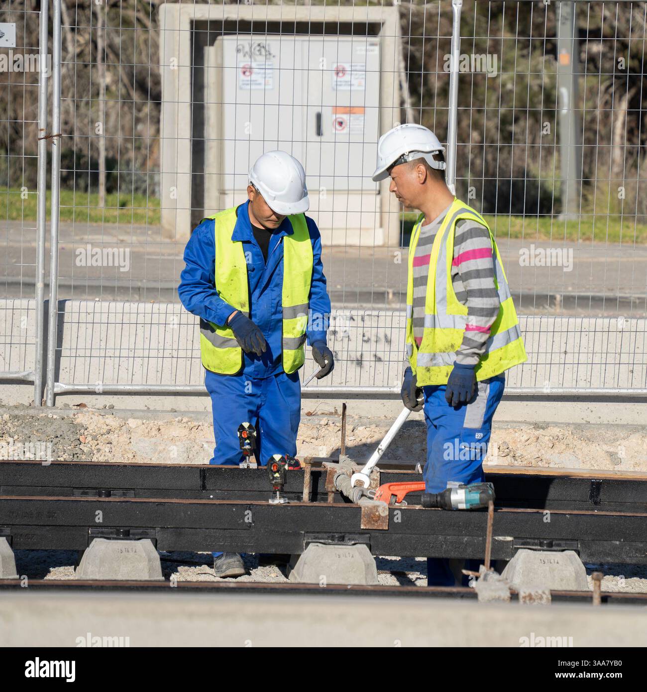 Jerusalem, Israel - December 23rd, 2024: Two men working on the new ...
