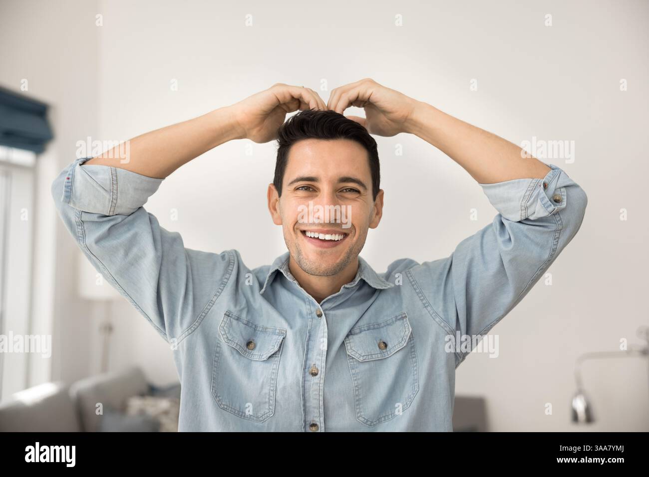 Man making heart gesture above his head using his hands Stock Photo - Alamy