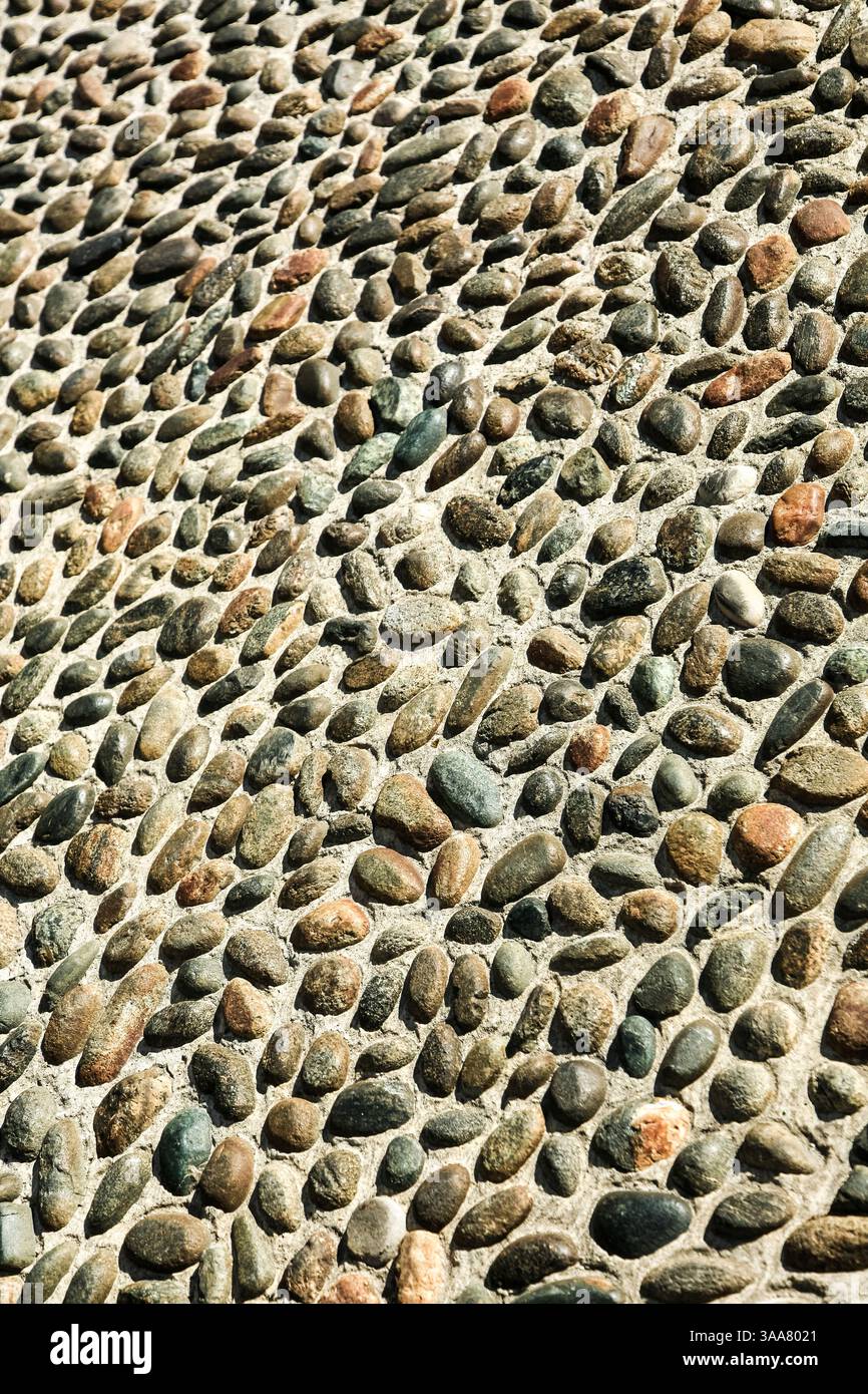 A wall made of rocks and pebbles. The wall is brown and gray. The rocks ...