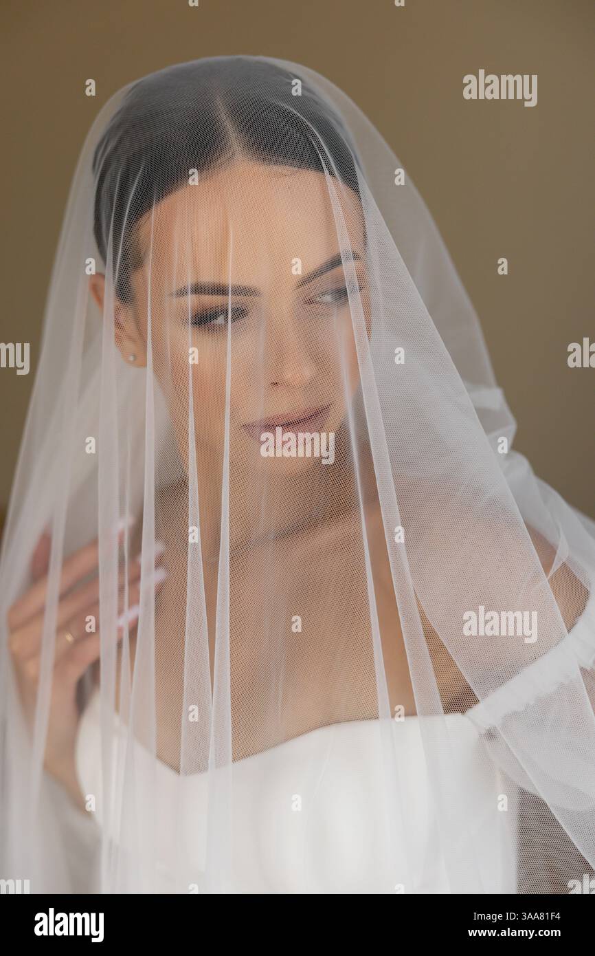 Elegant bride posing for a photo shoot, wearing a white wedding dress ...