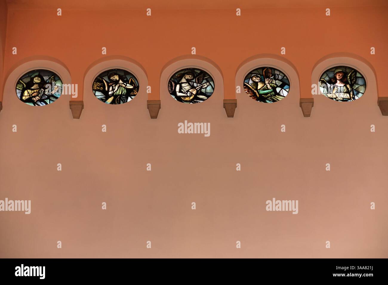 Elegant arched wall showcasing four round stained glass windows with ...