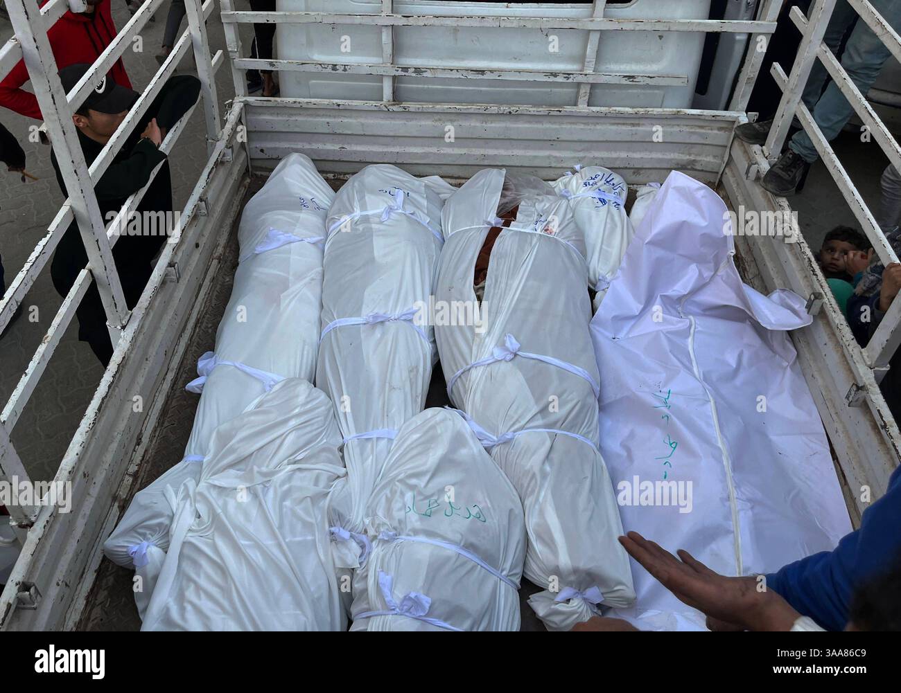 Palestinians mourn the deaths of nine members of the Hamada family at ...
