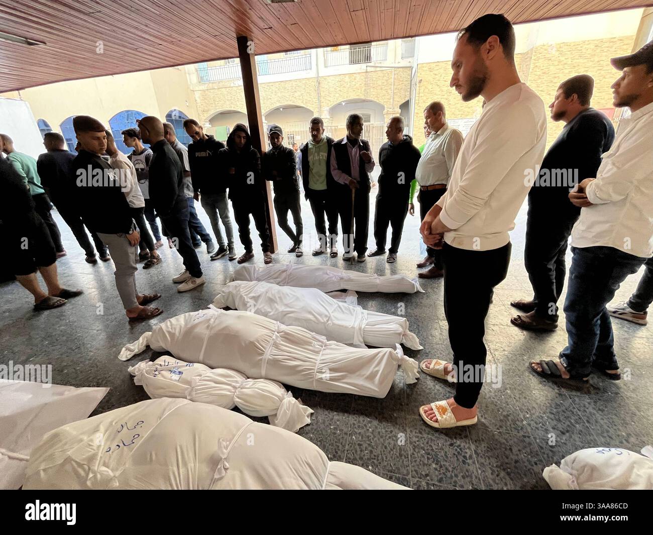 Palestinians mourn the deaths of nine members of the Hamada family at ...