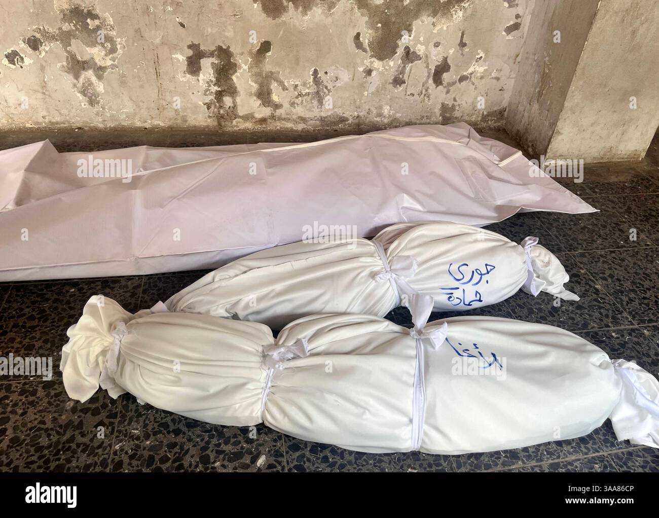 Palestinians mourn the deaths of nine members of the Hamada family at ...