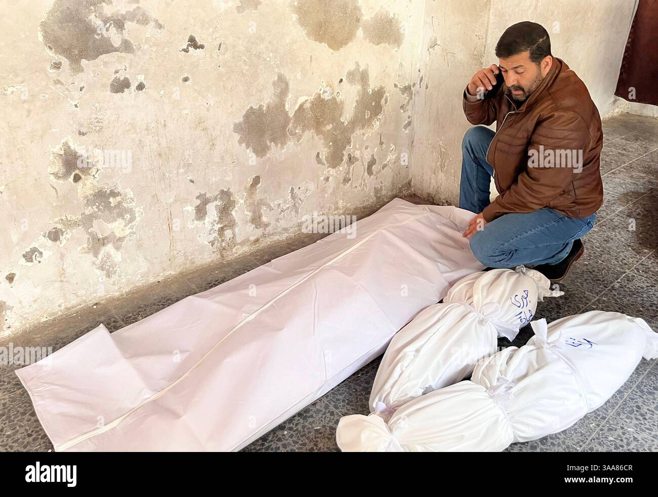 Palestinians mourn the deaths of nine members of the Hamada family at ...