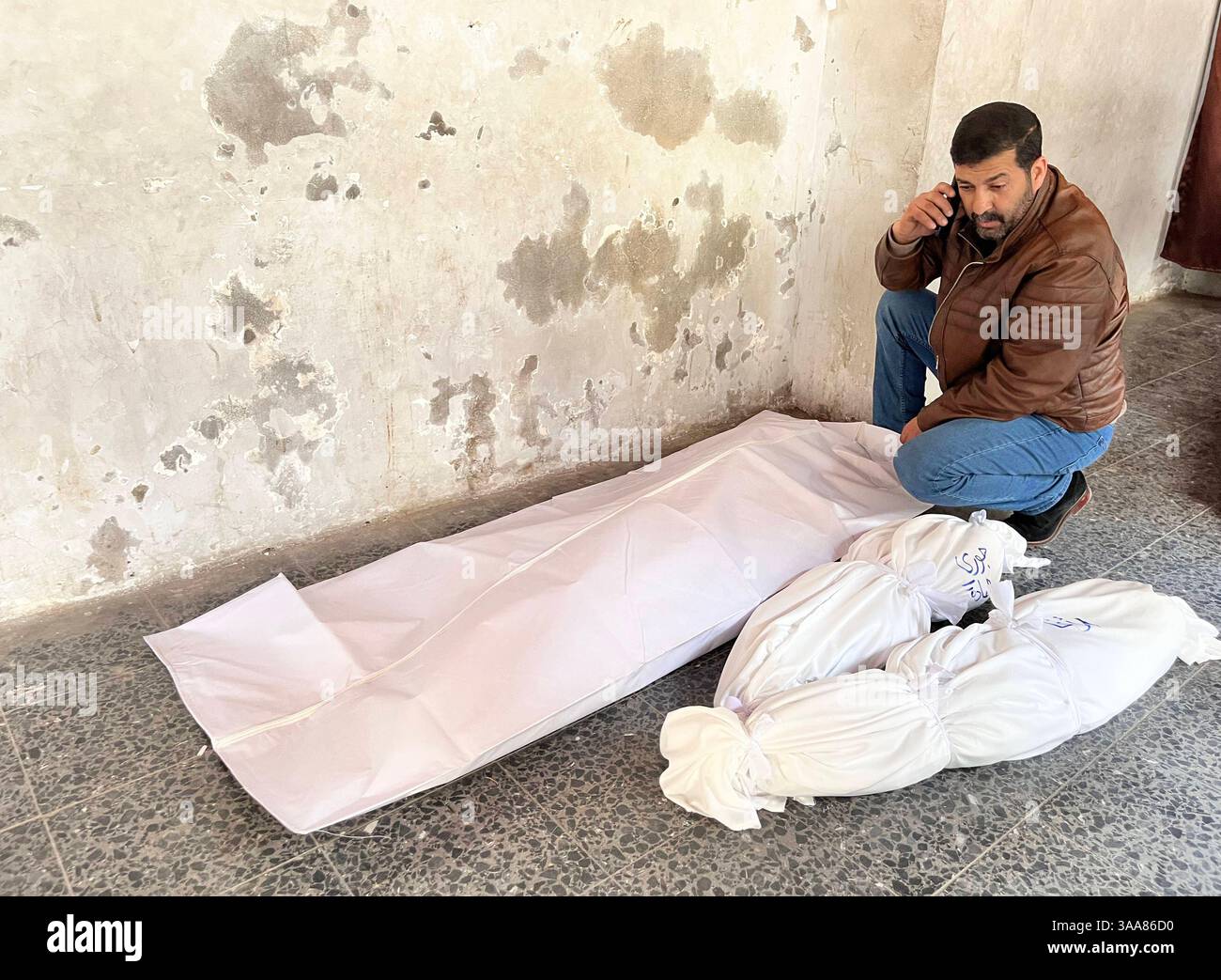 Palestinians mourn the deaths of nine members of the Hamada family at ...