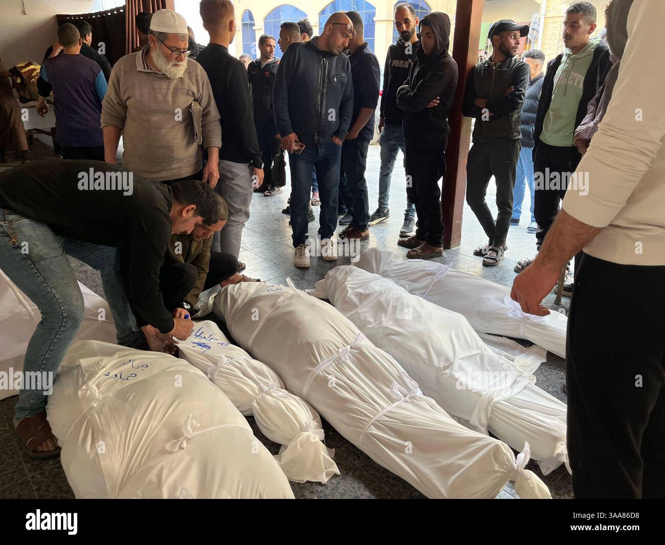 Palestinians mourn the deaths of nine members of the Hamada family at ...