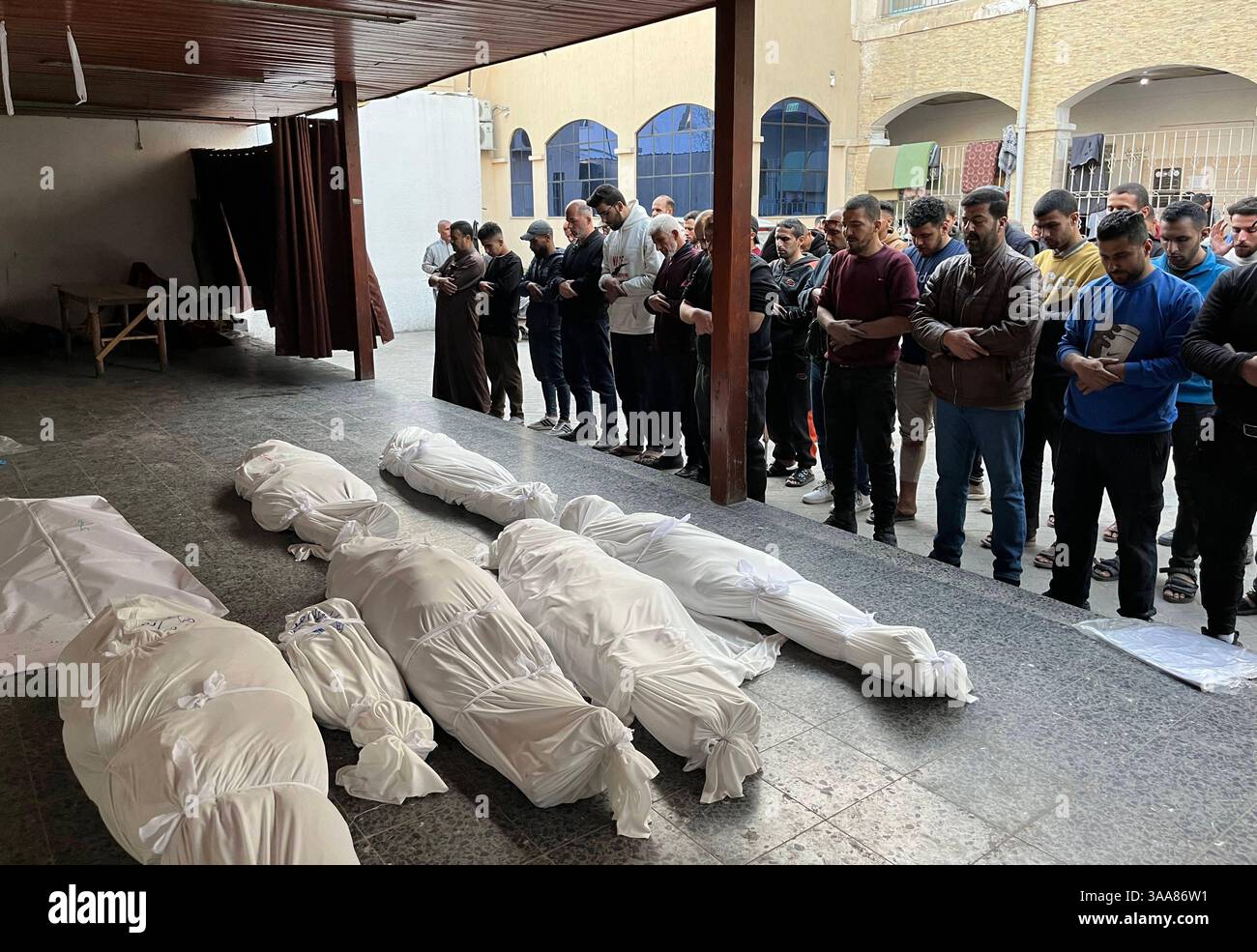 Palestinians mourn the deaths of nine members of the Hamada family at ...