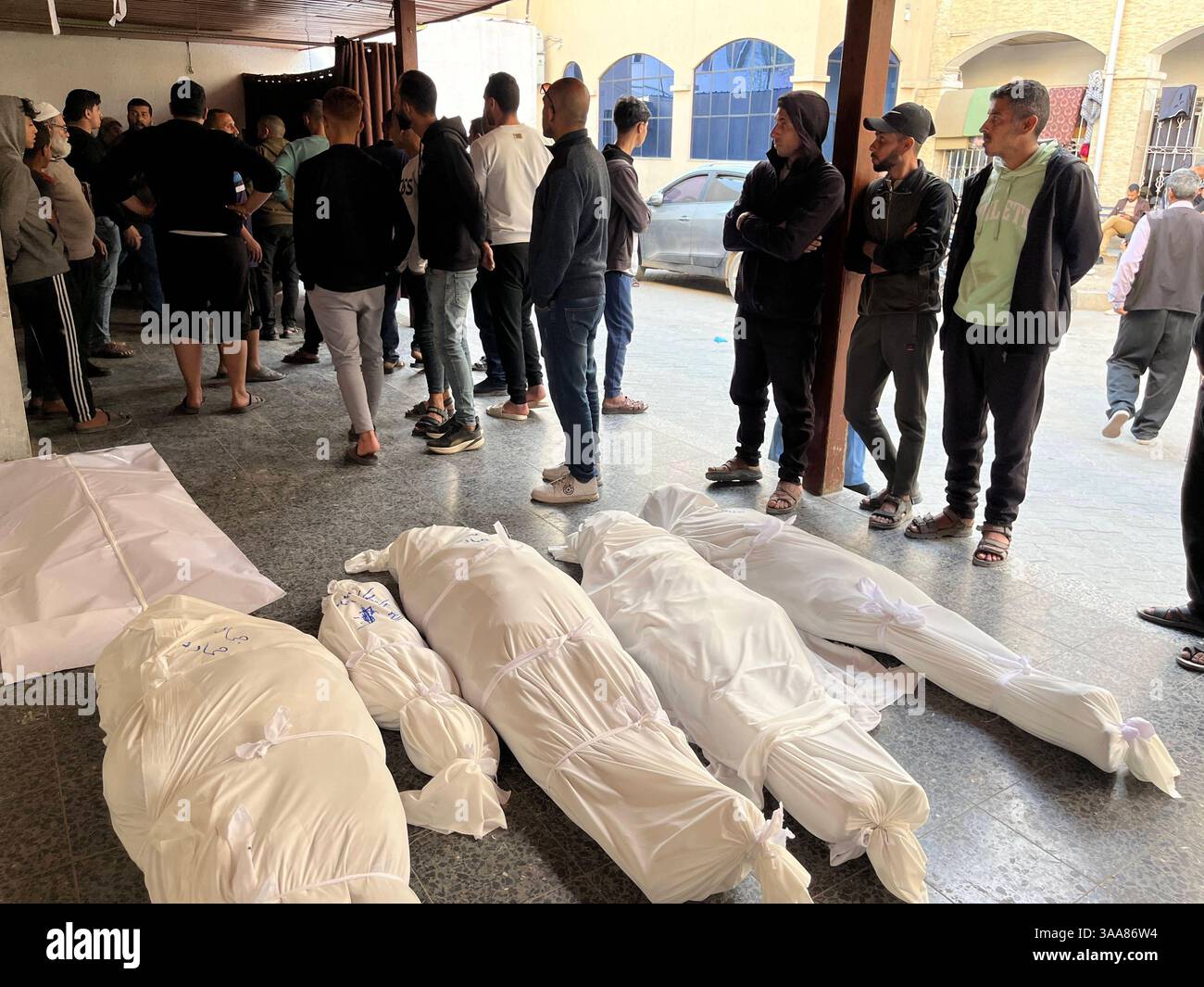 Palestinians mourn the deaths of nine members of the Hamada family at ...