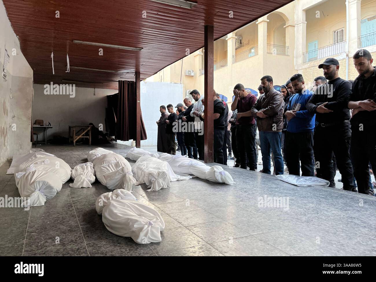 Palestinians mourn the deaths of nine members of the Hamada family at ...