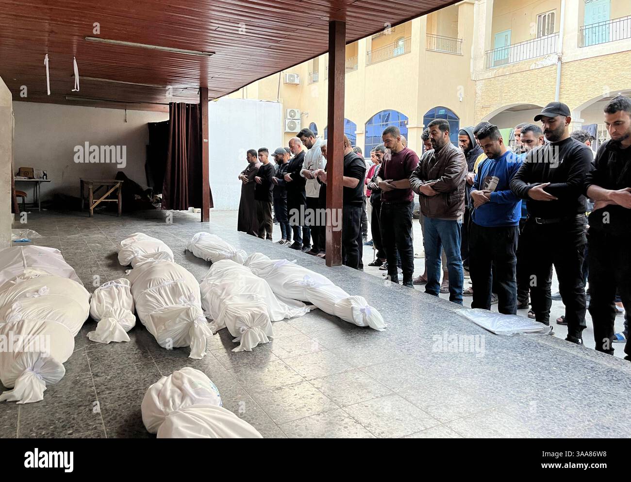Palestinians mourn the deaths of nine members of the Hamada family at ...