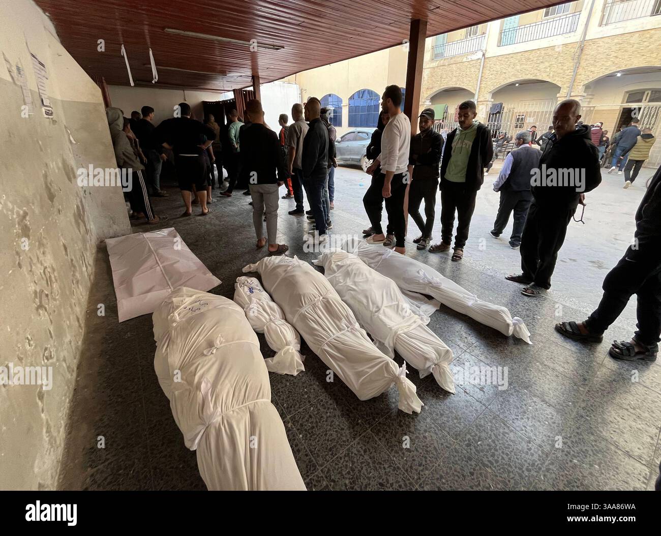 Palestinians mourn the deaths of nine members of the Hamada family at ...