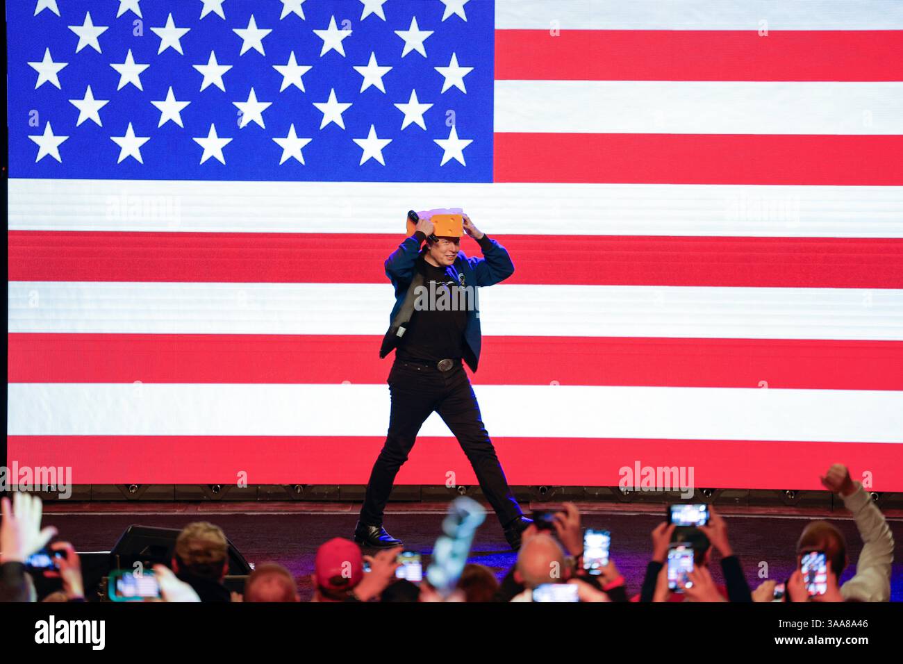 Elon Musk wears a cheesehead during a town hall Sunday, March 30, 2025 ...