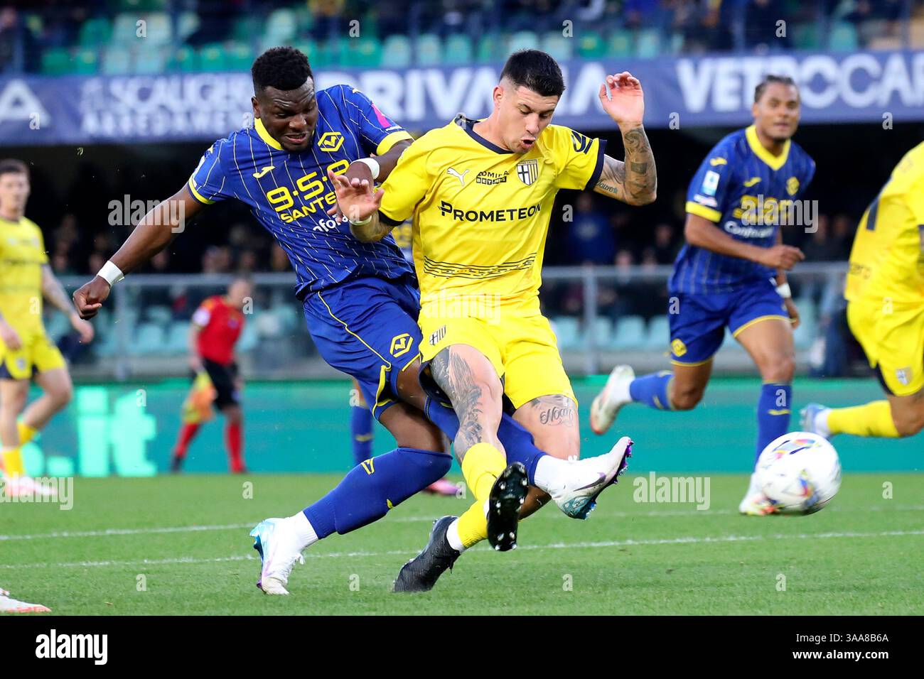Verona's Daniel Mosquera, left, kicks the ball past Parma's Lautaro ...