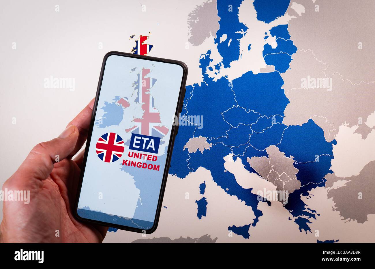Hand holding smartphone displaying ETA or Electronic Travel ...