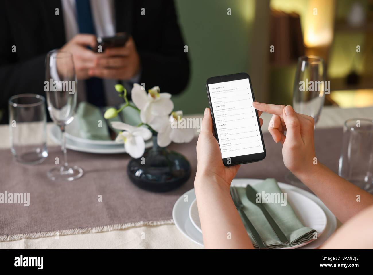 Couple choosing dishes from digital menu at restaurant, closeup Stock ...