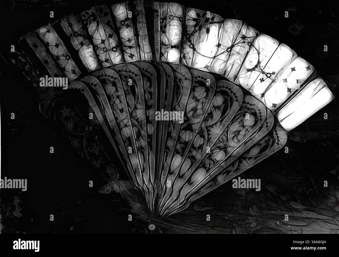 A beautifully crafted hand fan featuring intricate patterns and floral ...