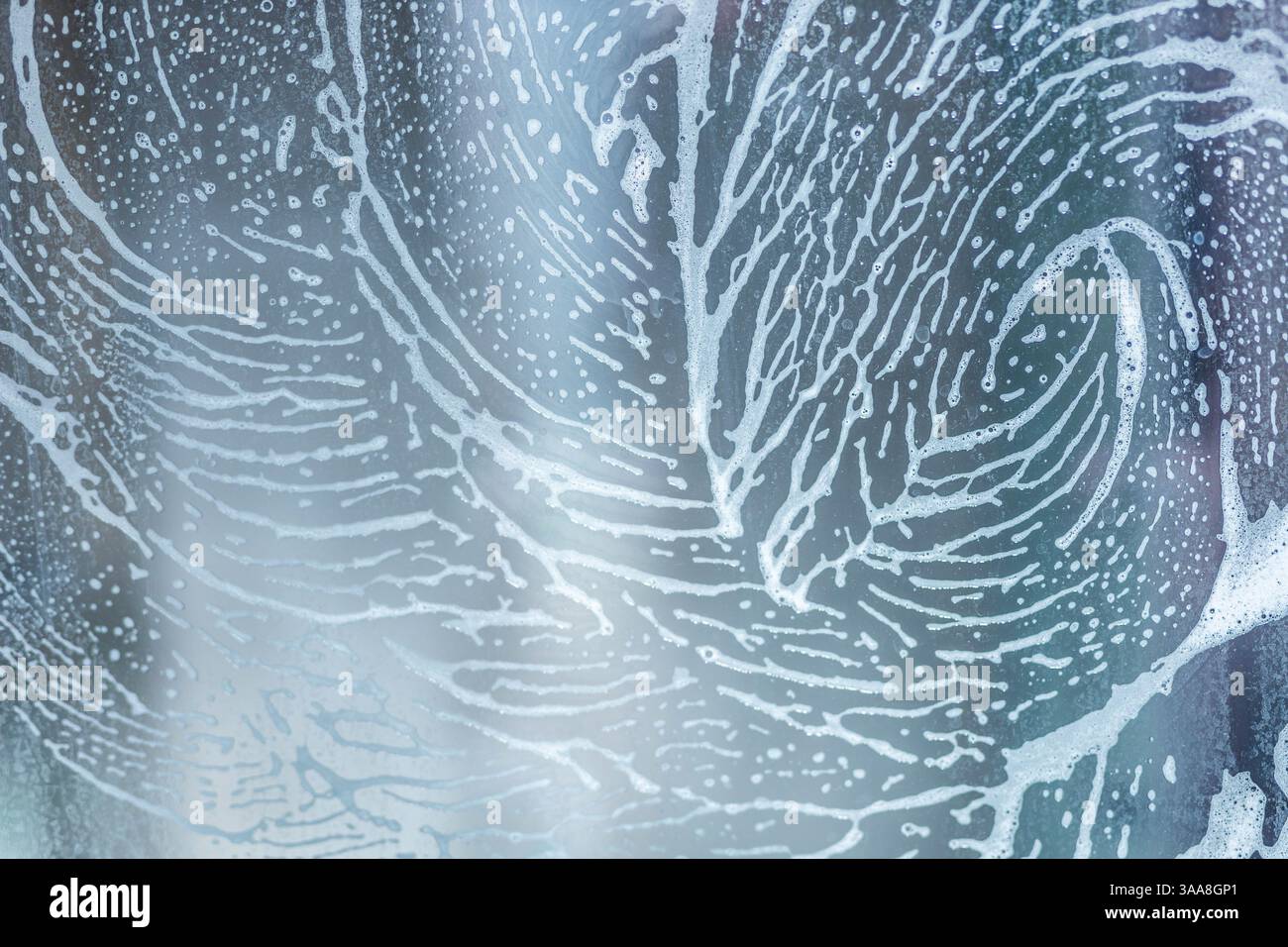 soap foam pattern wipe marks on window glass, window cleaning , blue ...