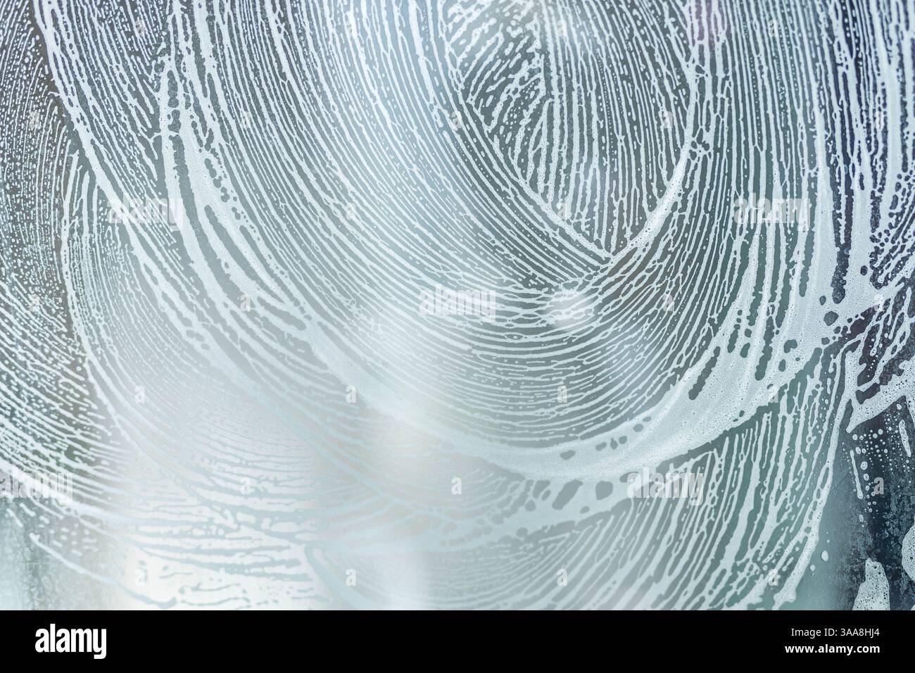 soap foam pattern wipe marks on window glass, window cleaning , blue ...