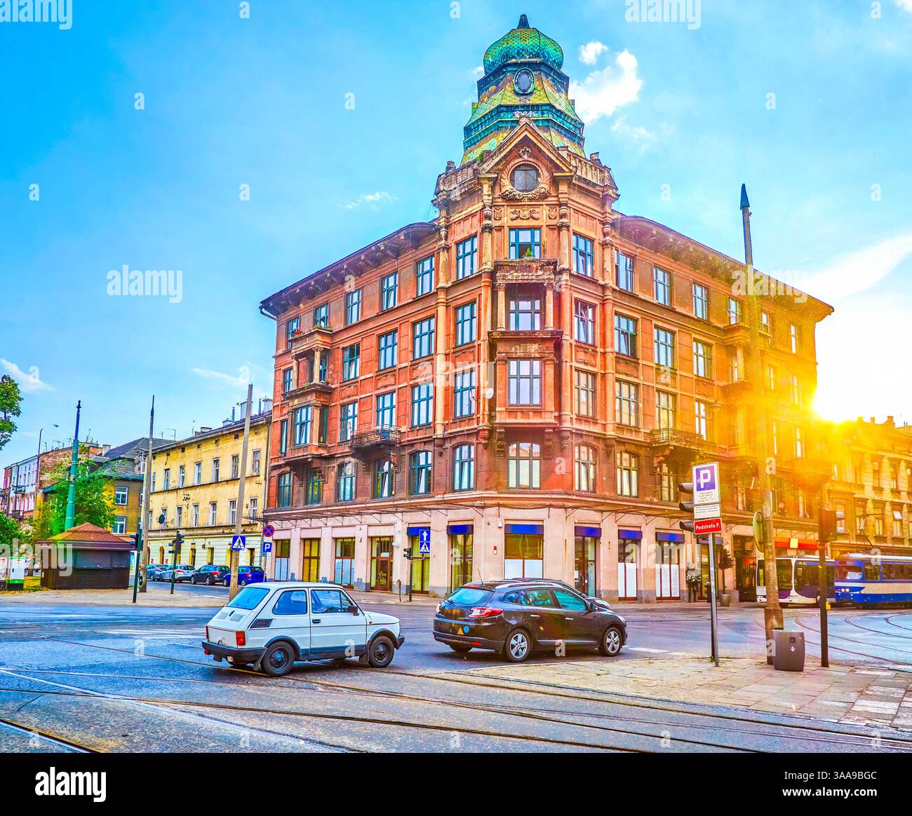 The beautiful view at the sunset on the old red edifice with green ...