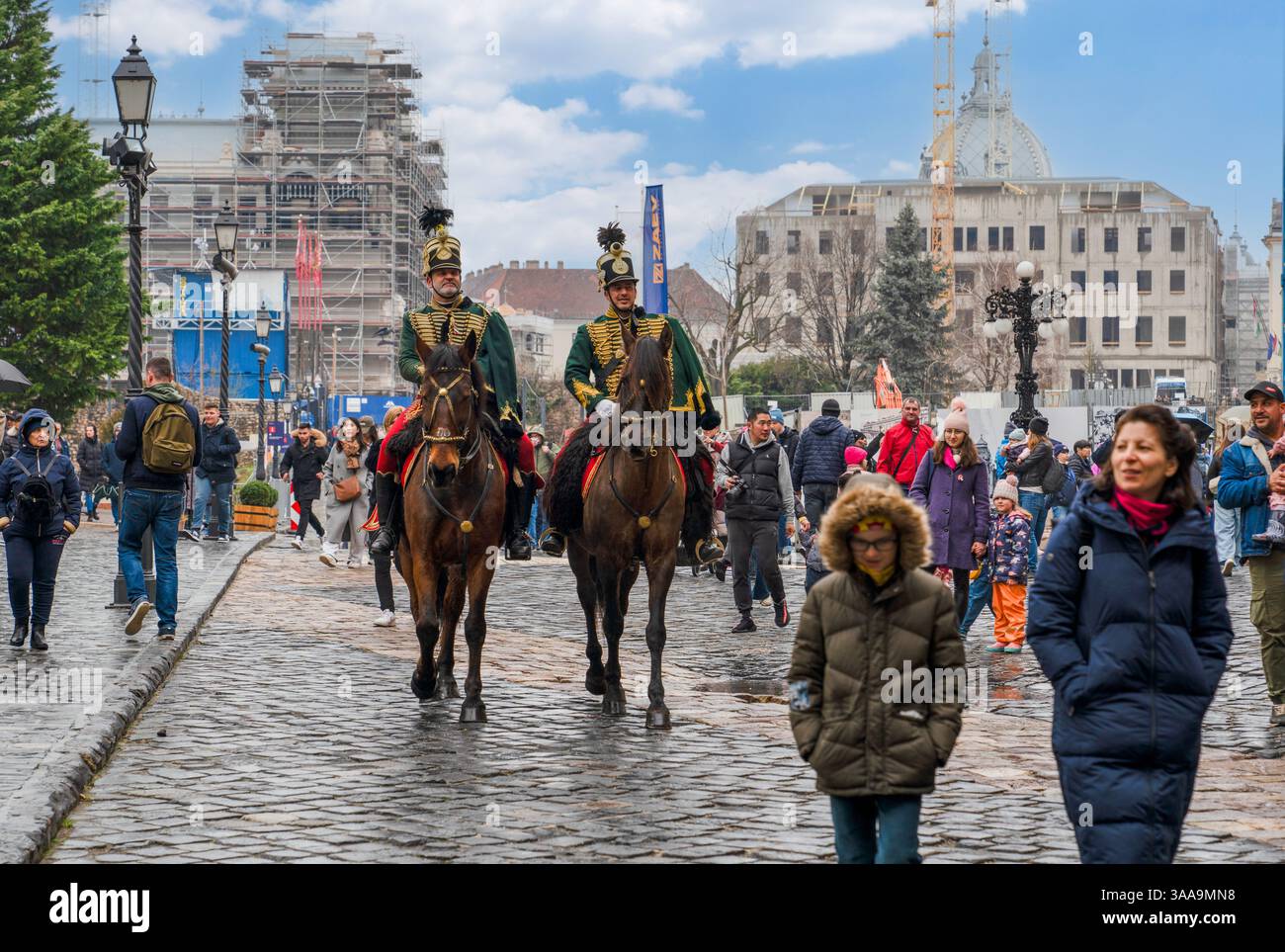 Budapest, Hungary - March 15, 2025: Two Hungarian soldiers in historical costume on horseback ...