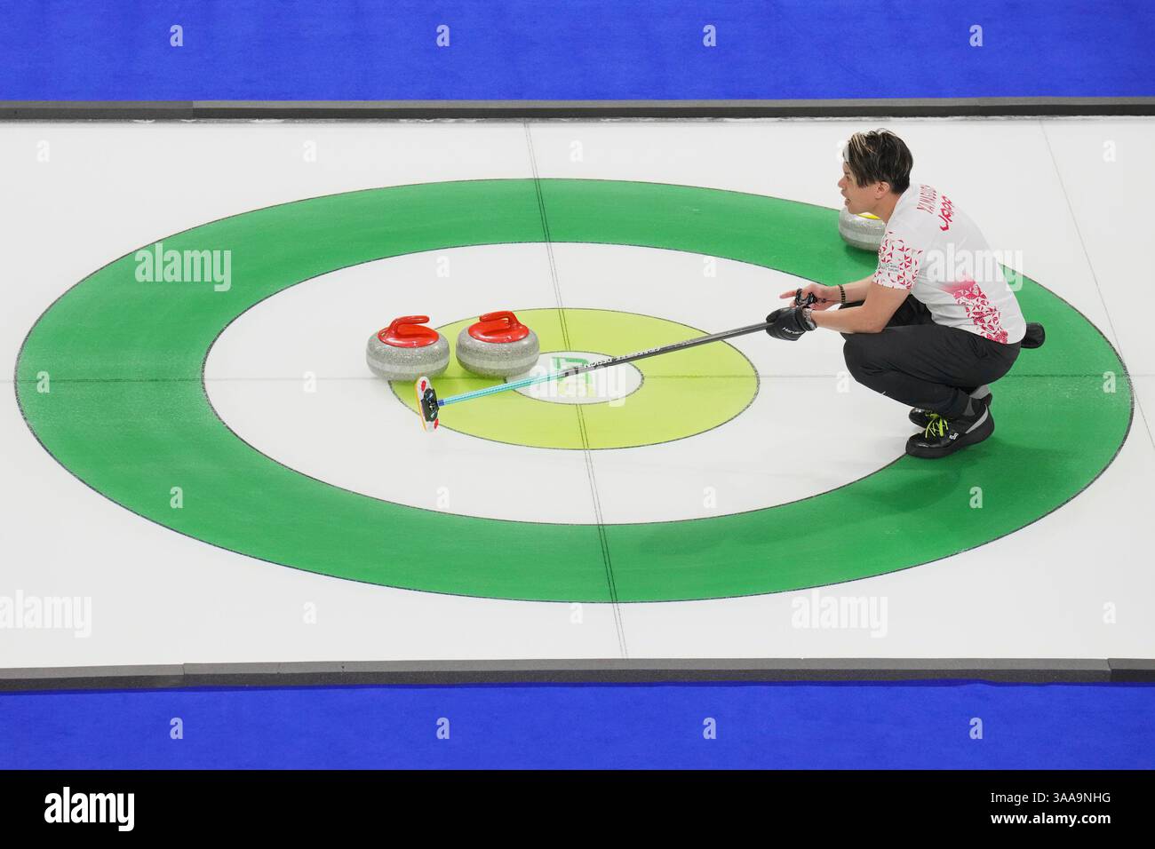 Japan's skip Tsuyoshi Yamaguchi lines up a stone during his country's ...