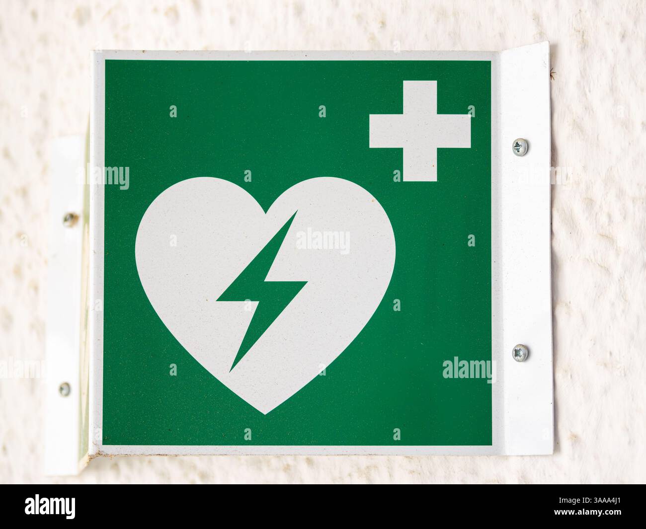 A green sign with a white heart and lightning bolt, indicating an ...