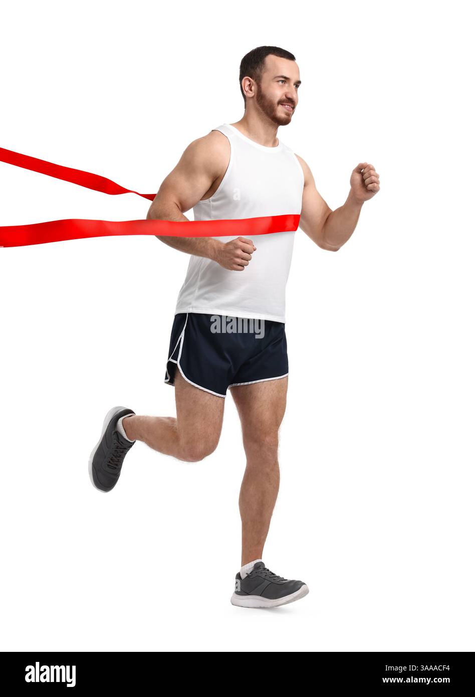 Happy sportsman crossing red finish line ribbon on white background ...