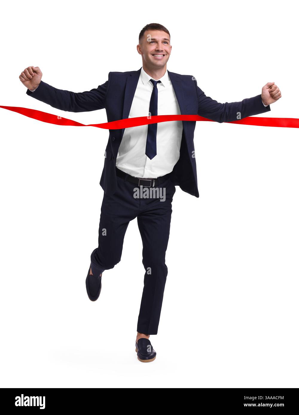 Happy businessman crossing red finish line ribbon on white background ...