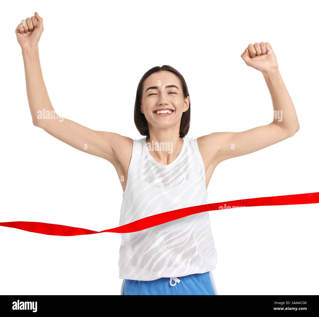 Happy sportswoman crossing red finish line ribbon on white background ...