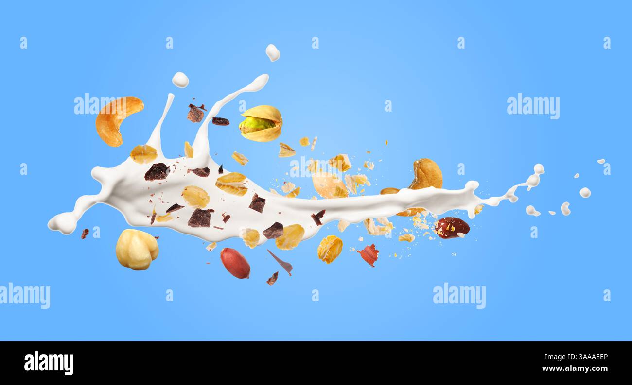Oat flakes, nuts, chocolate crumbs and splashing milk in air on light ...