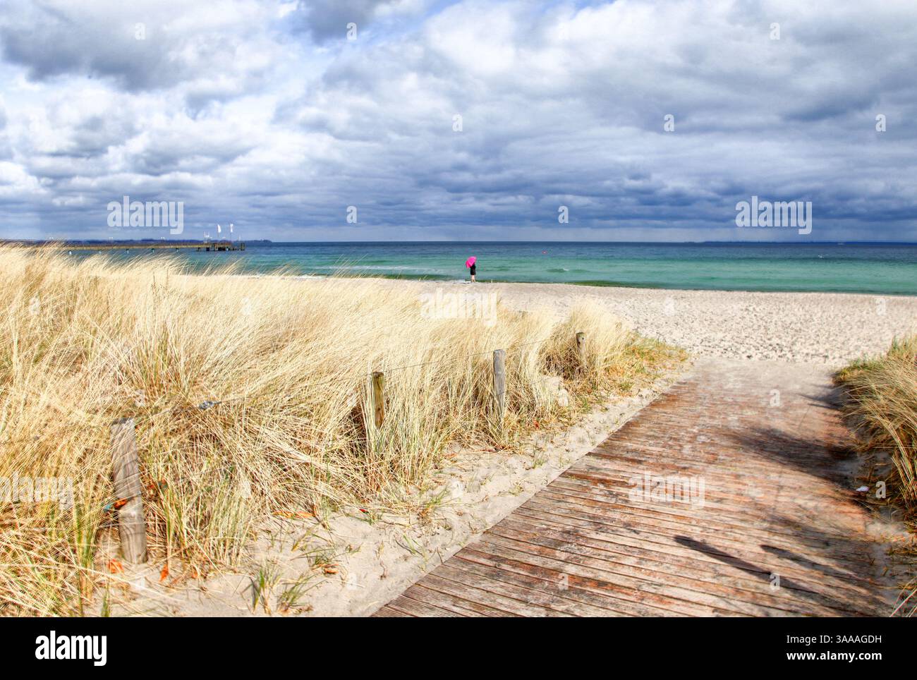 A red wooden boardwalk leading to the beach Baltic Sea in Germany. The ...