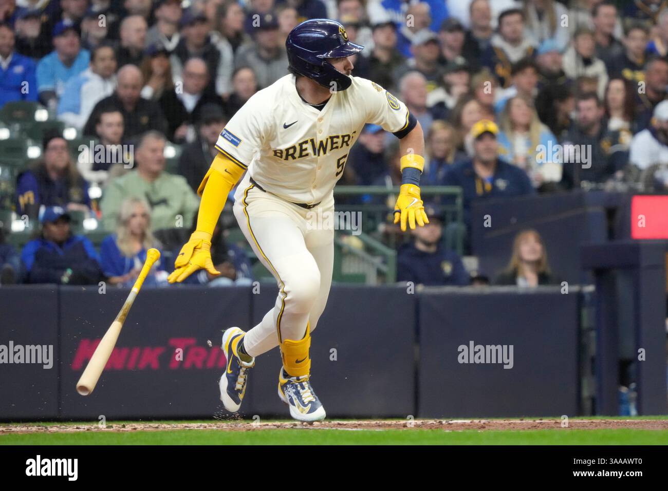 Milwaukee Brewers' Garrett Mitchell hits a ground ball single to third ...