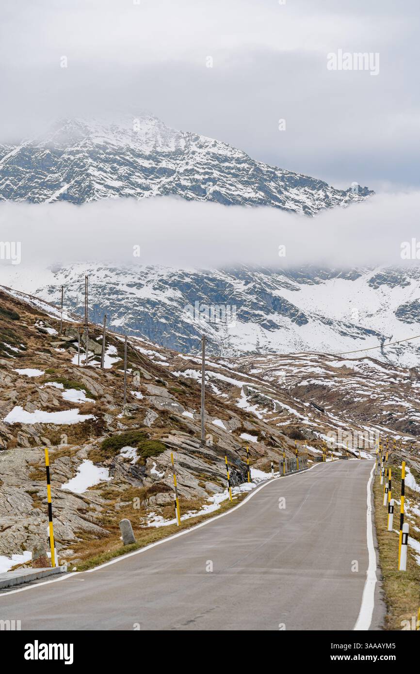 San Bernardino Pass in Switzerland. A road with a yellow and black pole ...