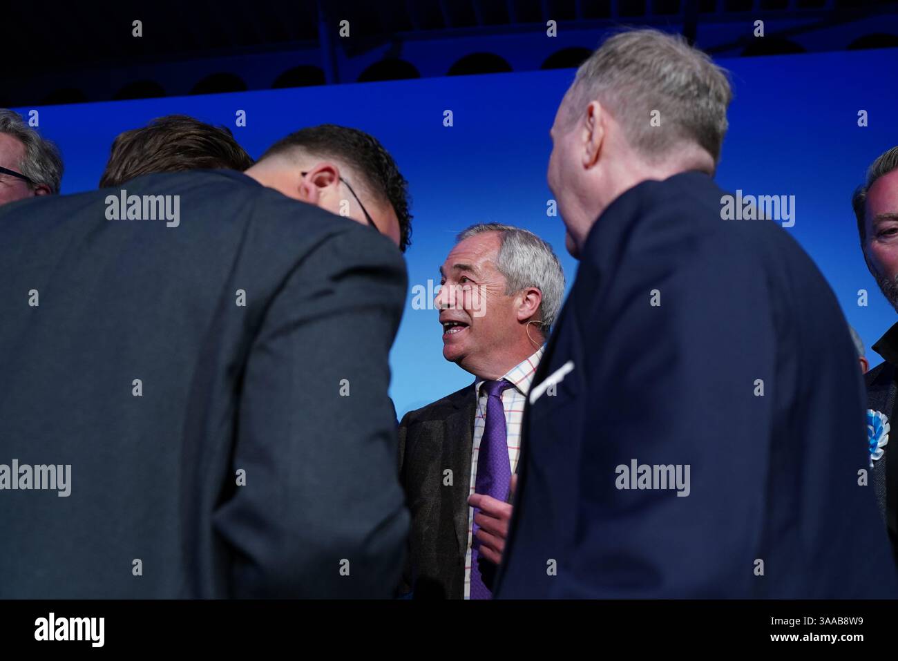 Reform UK leader Nigel Farage is joined on stage by prospective ...