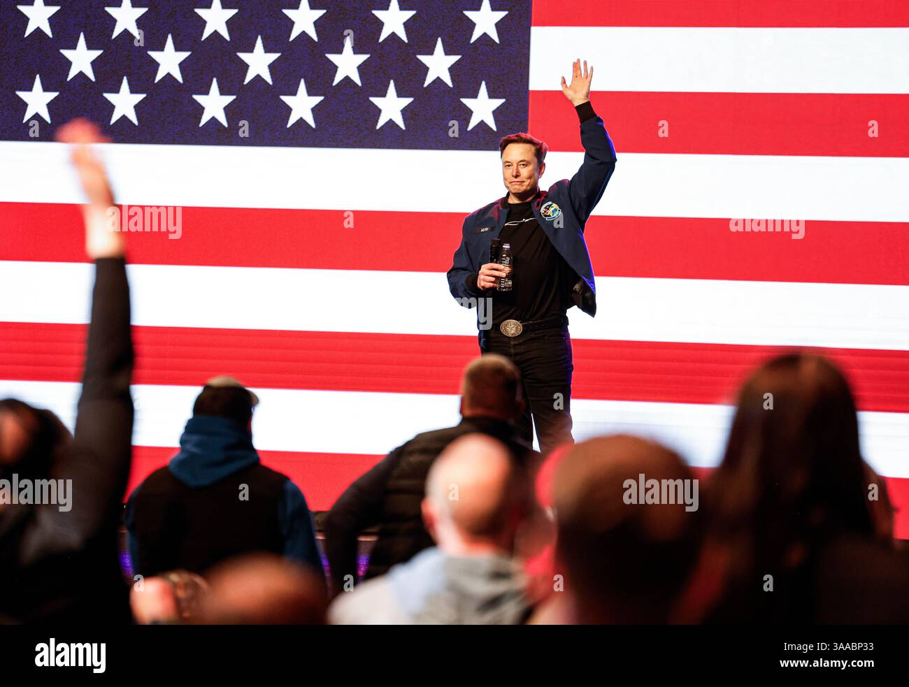 Elon Musk waves to supporters during a town hall Sunday, March 30, 2025 ...