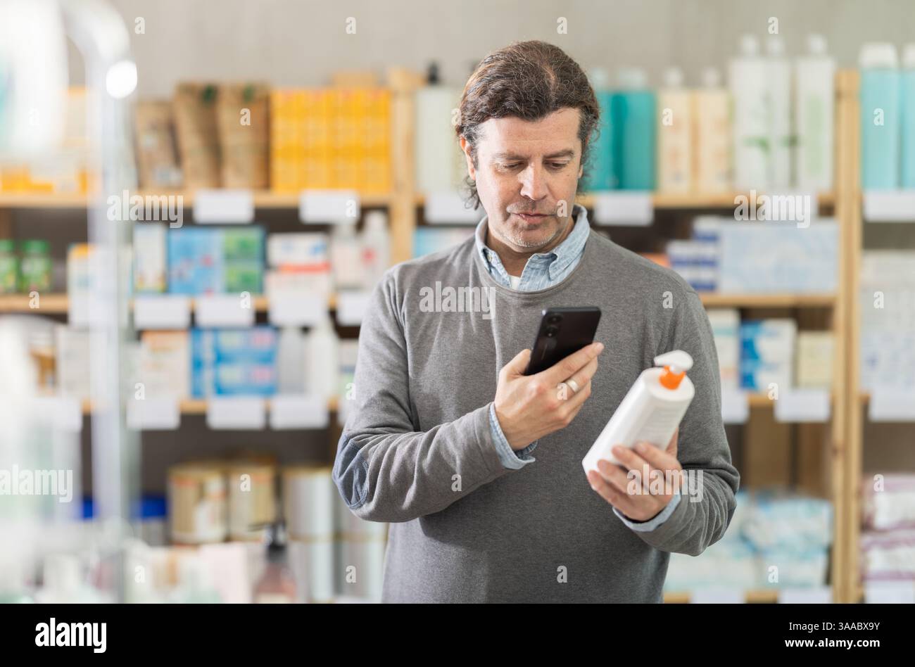 Male buyer scans code on package of cream to check expiration date ...