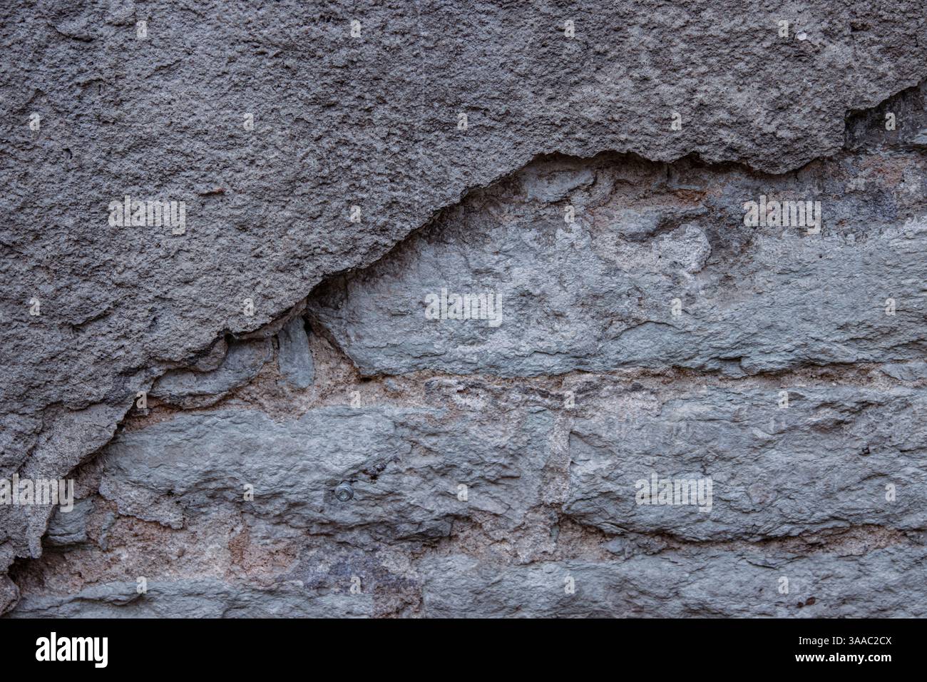 Closeup of a weathered bricks stone wall cracks and patina. Rough ...