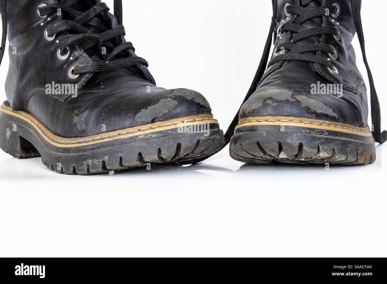 Closeup detail of a pair of rugged worn black ankle leather combat ...