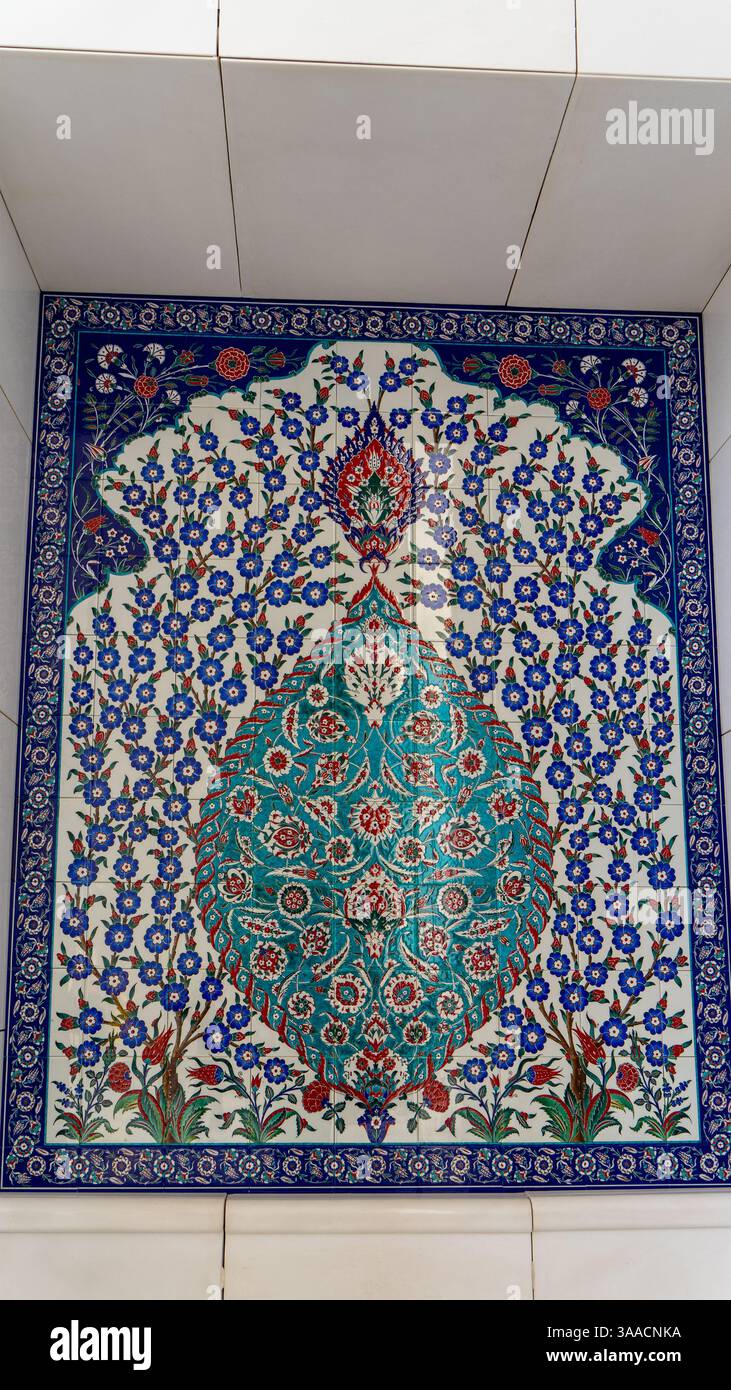 Panel of tiles with blue floral pattern with Arabic motifs on wall of ...