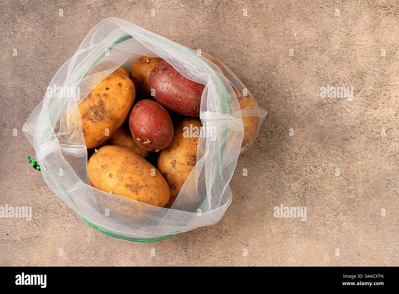 Various varieties of potatoes in fabric packaging. Healthy natural ...