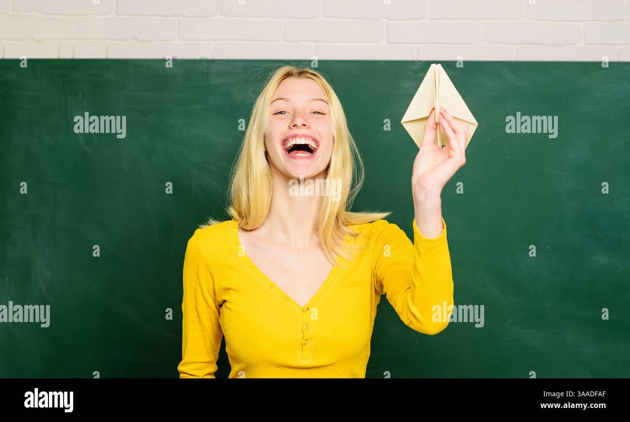 Happy girl throwing origami hi-res stock photography and images - Alamy